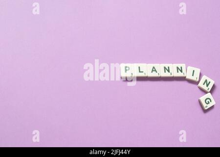 Planning formed of scrabble blocks on lilac background Stock Photo - Alamy