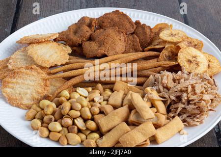A selection of Nigerian snacks - plantain chips, groundnut, kokoro ...