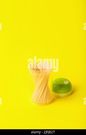 Plastic holder with toothpicks on yellow background Stock Photo - Alamy