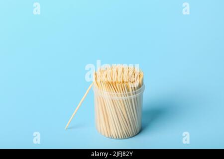 Plastic holder with toothpicks on blue background Stock Photo - Alamy