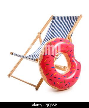 Striped deck chair with inflatable ring on white background Stock Photo ...