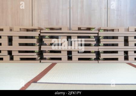 A Japanese folding table made of wood is set at the center of the ...