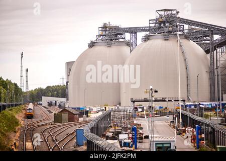 Long train of Drax Biomass rail freight wagons crossing the King George ...