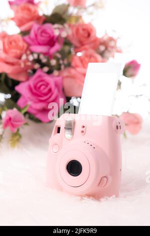 The pink instant camera with blank instant films Stock Photo - Alamy