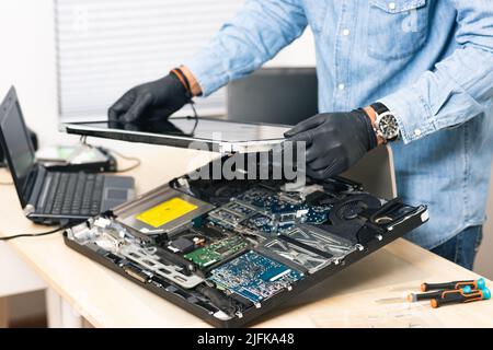 Technician reparing a broken computer. Computer service and repair ...