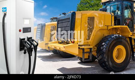 Electric construction machines with charging station. Concept Stock ...