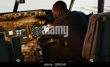 Captain inserting destination coordinates on cabin dashboard, using ...
