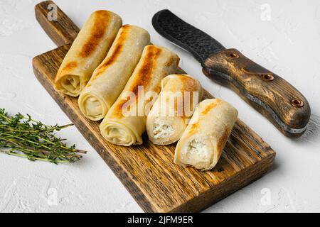 Fried georgian crepes stuffed with suluguni on black dark stone table ...