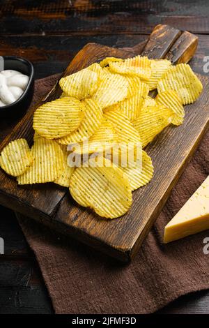 Wavy Ranch Flavored Potato Chips on black dark stone table background ...