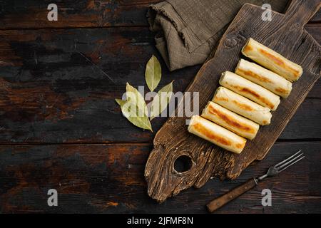 Fried georgian crepes stuffed with suluguni on black dark stone table ...