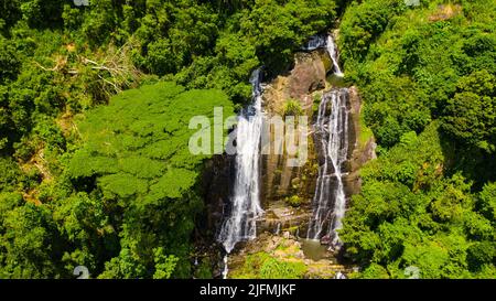 Waterfall in the green forest. Hunas Falls in the jungle. Hunnasgiriya ...