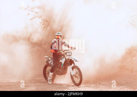 Live shot of male sportsman training on motorbike at hot summer day ...