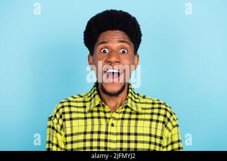 Photo of impressed brunette young afro hairstyle lady look empty space wear khaki shirt isolated ...