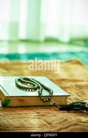 Greeting card for Ramadan with Koran and prayer beads on light ...