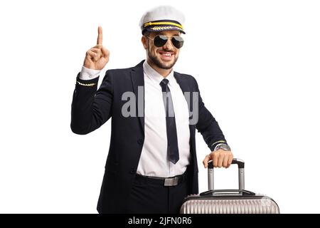 Pilot with a suitcase pointing up at the airport isolated on white ...