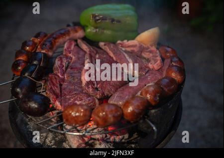 Typical Uruguayan and Argentine Asado Cooked on fire. Entrana and Vacio ...