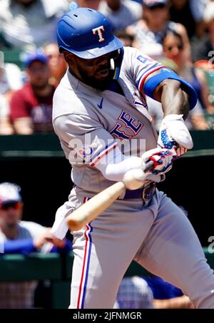 Texas Rangers right fielder Adolis Garcia holds up the ball for the ...