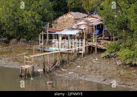 A simple house on a muddy riverbank Stock Photo - Alamy