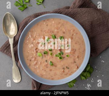 Lentil soup in a bowl with seasoning over stone background Stock Photo ...