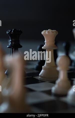 A vertical shot of chess figures - the concept of overcoming the ...