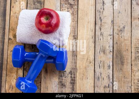 Two red dumbbells on wood slices, Christmas bauble, tree branches ...
