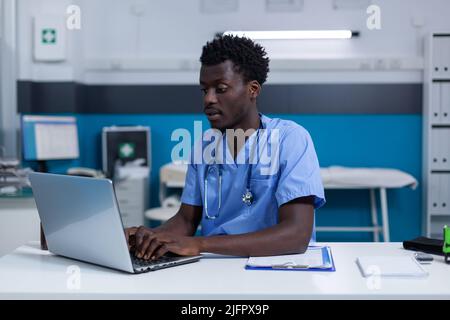 Hospital nurse verifying patient medical records and updating treatment ...
