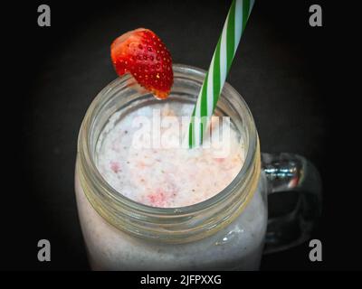 High angle shot of a strawberry in a green plate on the table Stock ...