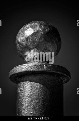 Shiny metal railing barrier fence stand on concrete footpath beside ...