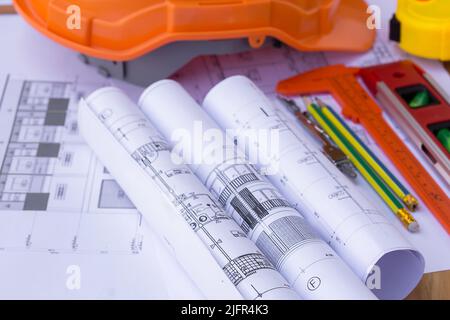 Architecture plan and rolls of blueprints with tool kit for the project ...