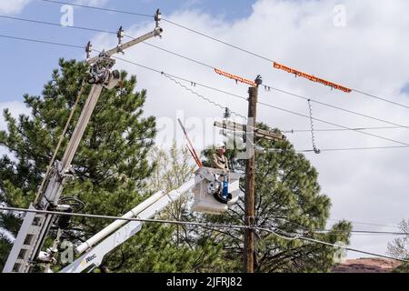 Electrical workers make perform maintenance on live electrical ...
