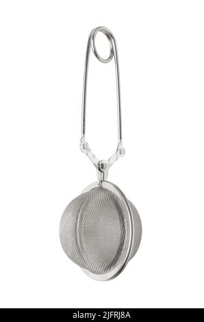 metal tea strainer in a white stoneware bowl and paper bag on a white ...