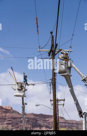 Electrical workers make perform maintenance on live electrical ...