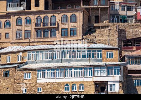 facades of houses located in tiers on a steep slope in the village of ...