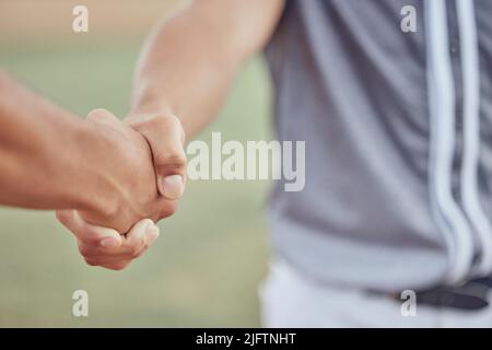 Closeup of two sportsmen shaking hands before a game. Hands pf baseball ...