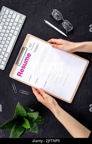 Employer reviews resume application form on office table Stock Photo ...