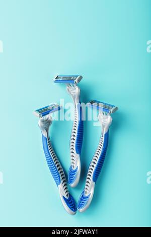 Blue shaving machine with sharp blades on the background of ice cubes ...