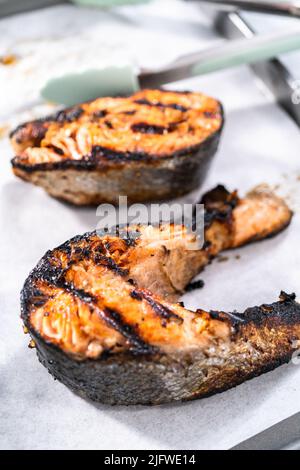 Grilled salmon steaks on a baking sheet with parchment paper Stock ...