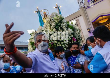 Devotees carry the carriage of Blessed Virgin Mary during the solemn ...