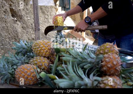 Cutting the pineapple with a sharp knife. Healthy Fruit for human ...