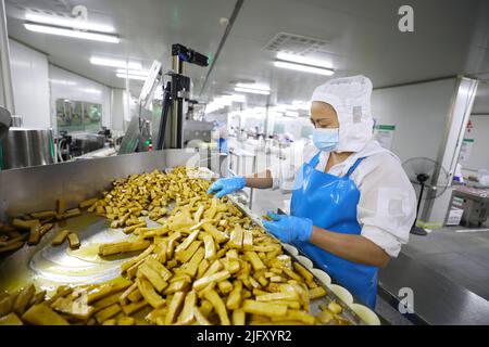 CHONGQING, CHINA - JULY 5, 2022 - Workers spot check the quality of ...