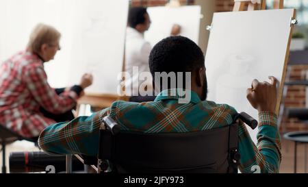 Young woman with disability learning to draw sketch on canvas ...