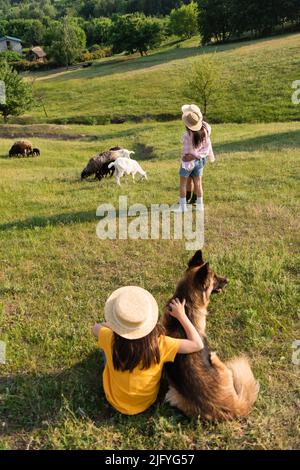 Woman child dog straw hat smiling outdoor park bench traditional ...