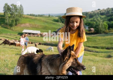 Woman child dog straw hat smiling outdoor park bench traditional ...