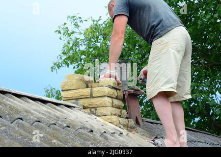 Building chimney from bricks. Bricklaying new house chimney Stock Photo ...