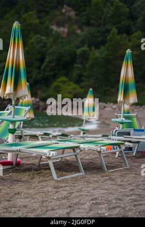 Sun loungers and umbrellas on the Sassolini beach Stock Photo - Alamy