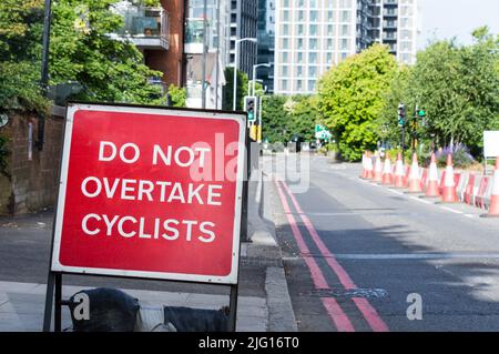 Do Not Overtake Cyclists road sign in a single lane road Stock Photo ...