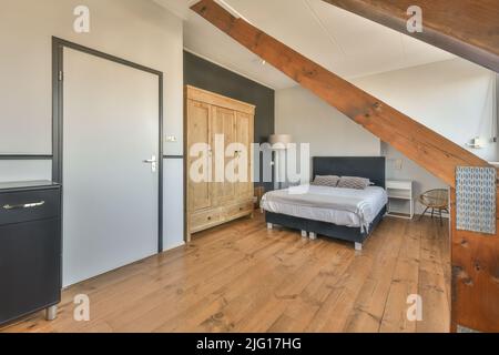 Comfortable bed placed near green wall in modern minimalist style ...