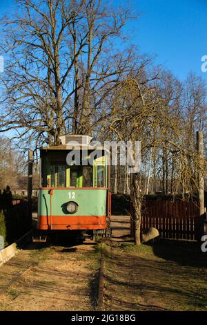 An old-fashioned transport wagon stands prominently, featuring a large ...