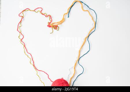 Heart shape from colorful threads. Bundles of pink threads forming ...