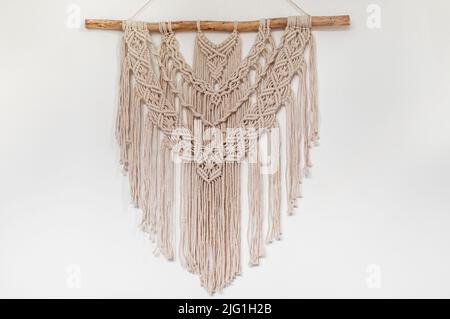 wall decor of woven threads in the style of macrame on a white ...